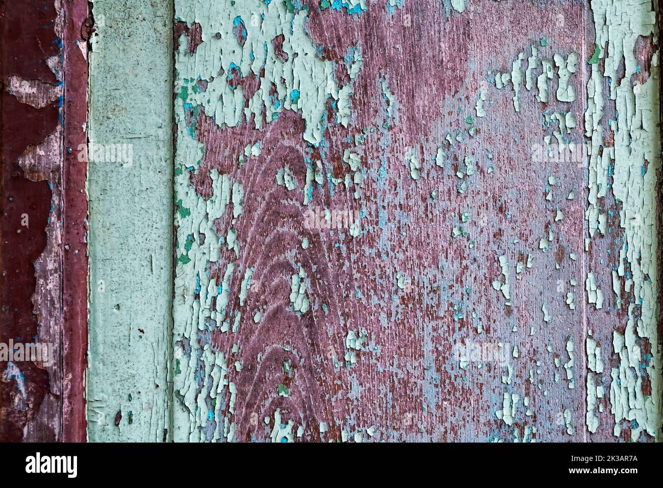 Colorful craquelure of the delaminated paint on wooden door background ...