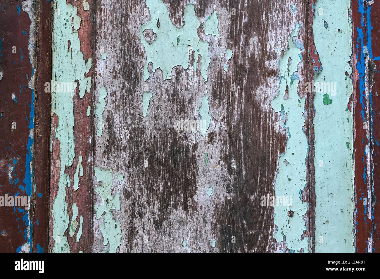 Colorful craquelure of the delaminated paint on wooden door background ...