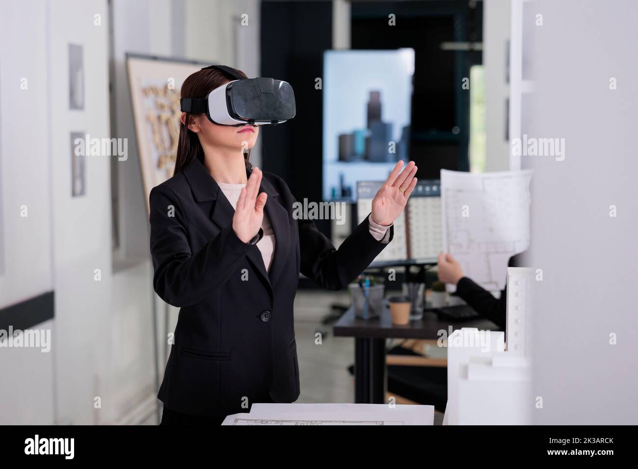 Architect in ar helmet touching virtual building, working on project ...