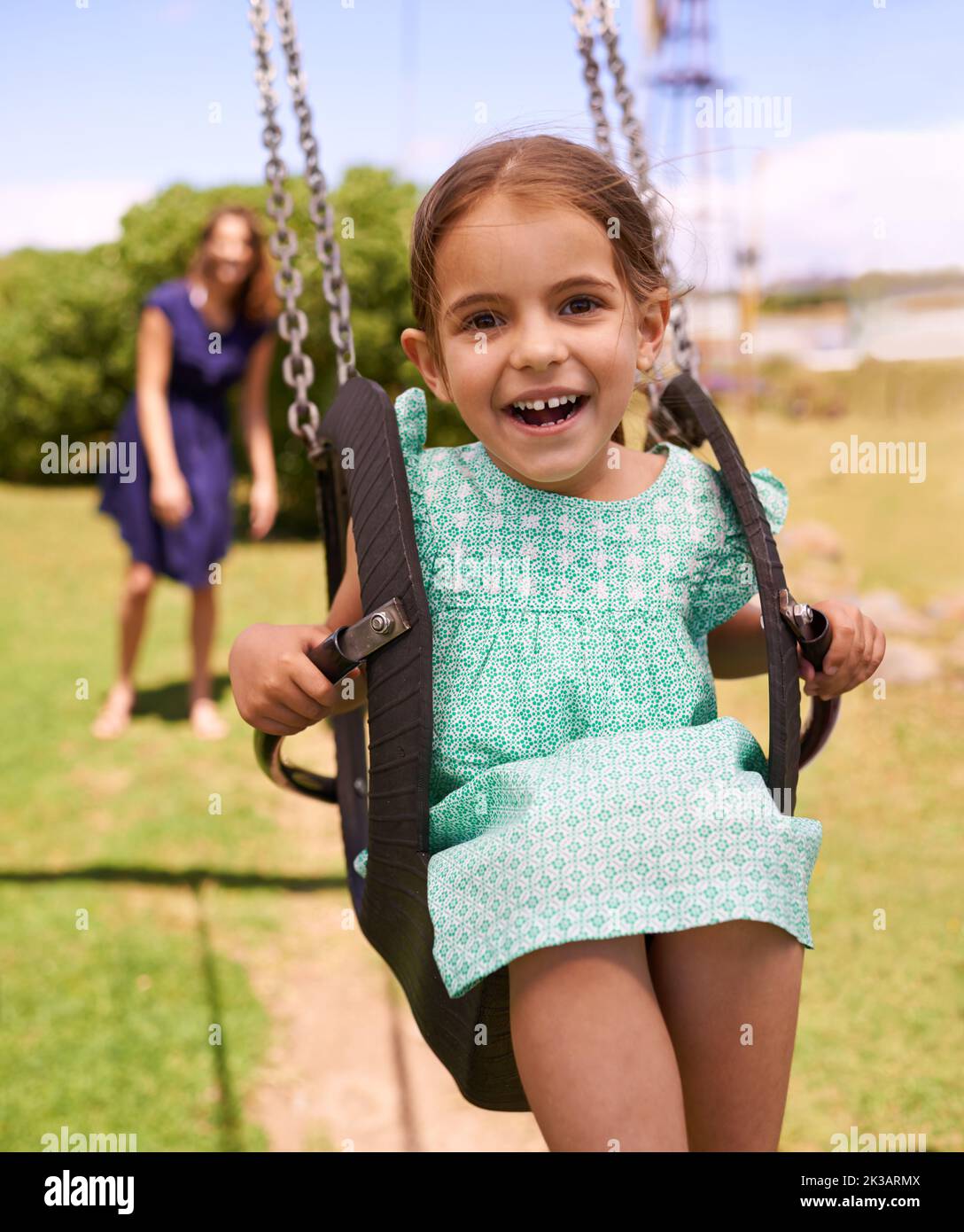 Nothing better than a swing. a young girl playing on a swing outsdie ...