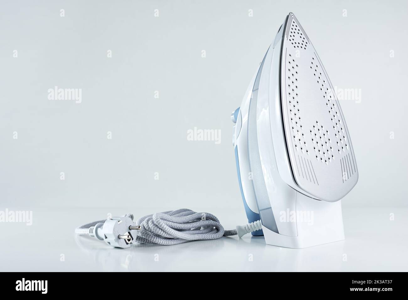 New iron with electrical cable on white background, Modern household ...