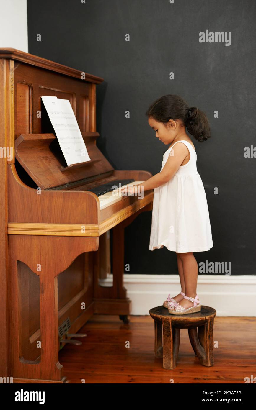 Virtuoso in the making. a little girl playing the piano Stock Photo - Alamy