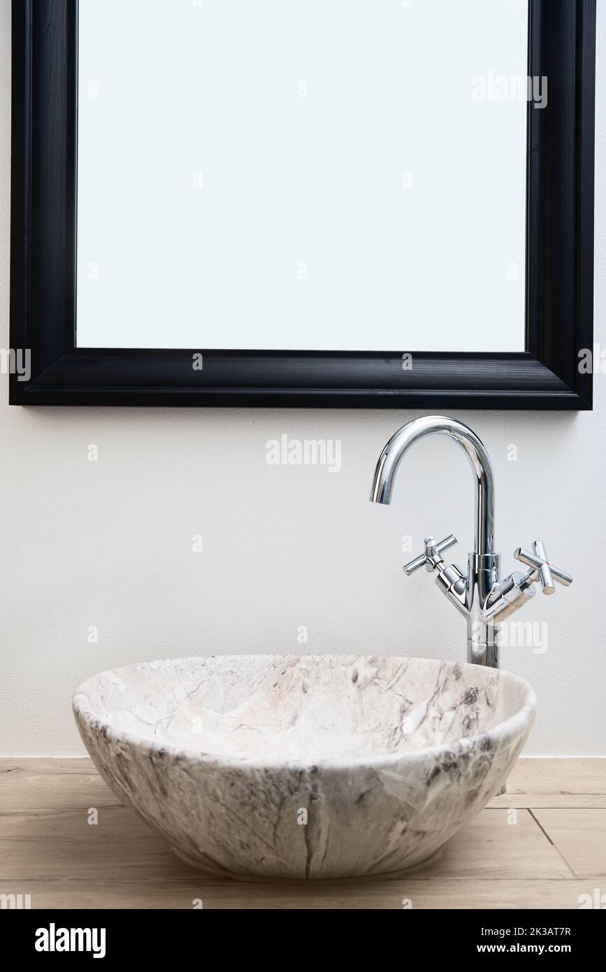 Detail of modern bathroom interior with mirror on wall, steel faucet ...