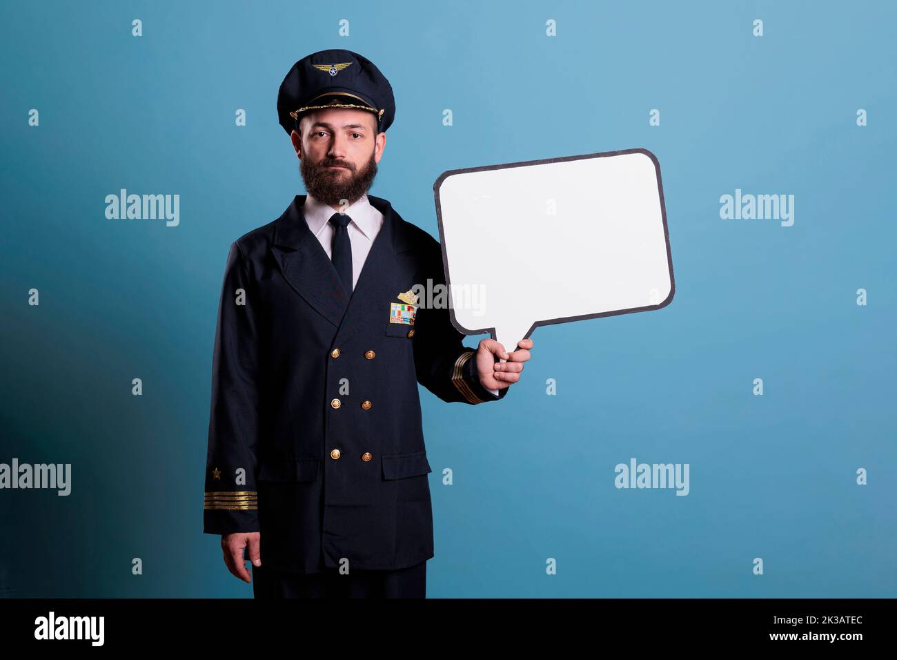 Airplane pilot pointing with finger at white blank speech bubble ...