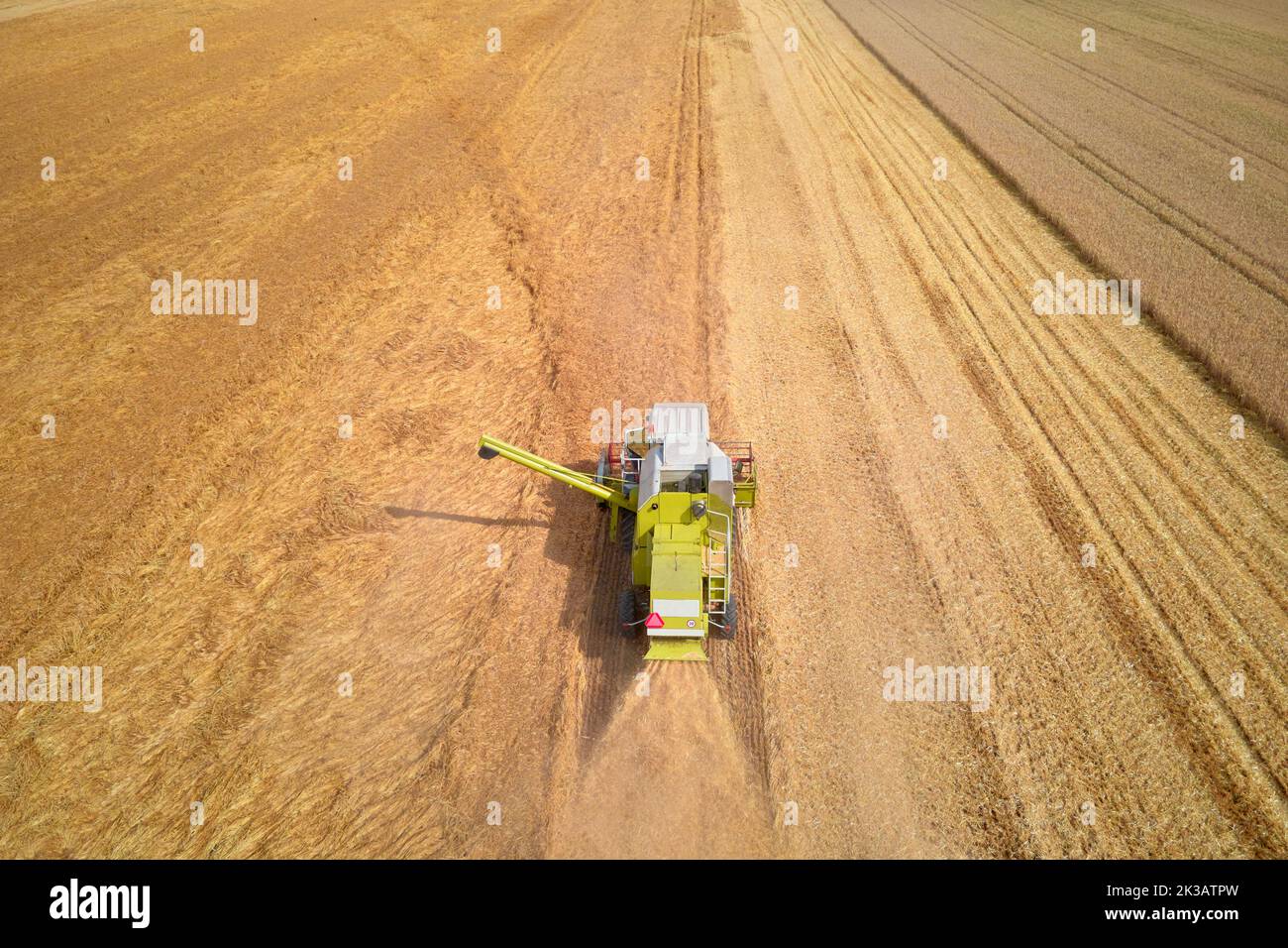 Harvest season, Aerial view of harvesting combine working in ...