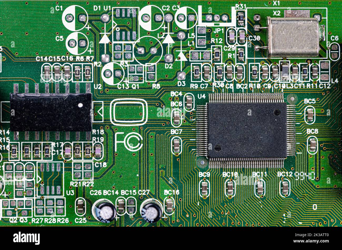 macro closeup shot of microchip on green printed circuit board ...