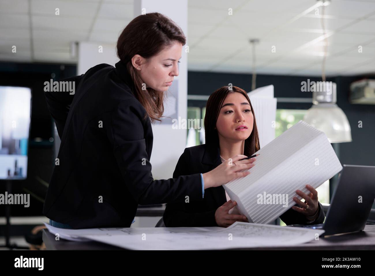 Architects Working With Blueprints Discussing Architectural 3d Model In Coworking Space