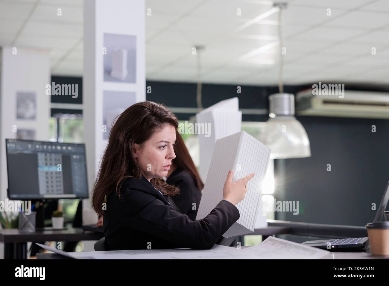Architect holding 3d printed model, discussing building prototype on ...