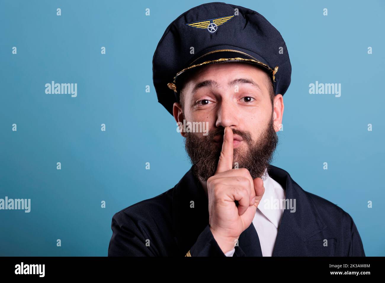 Airplane pilot showing silent gesture, looking at camera with ...