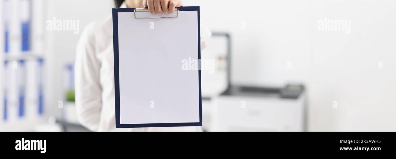 Woman in the office shows a folder with a document, mock up Stock Photo ...