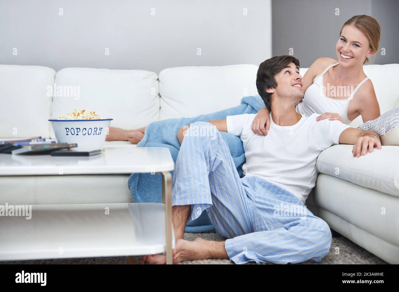 Ready to watch the movie. A young couple watching a movie at home Stock ...
