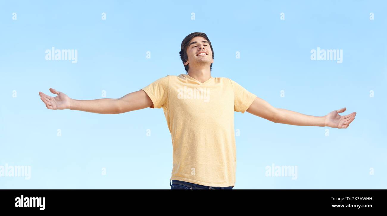 Feel the freedom. A young man standing with his arms outstretched Stock ...