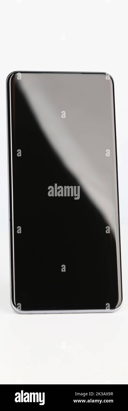 Black smartphone stands upright on a white background Stock Photo - Alamy