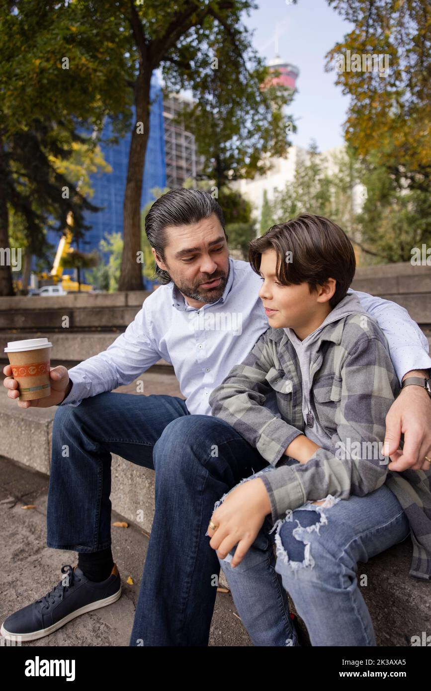 Boy talking to father in the park hi-res stock photography and images ...