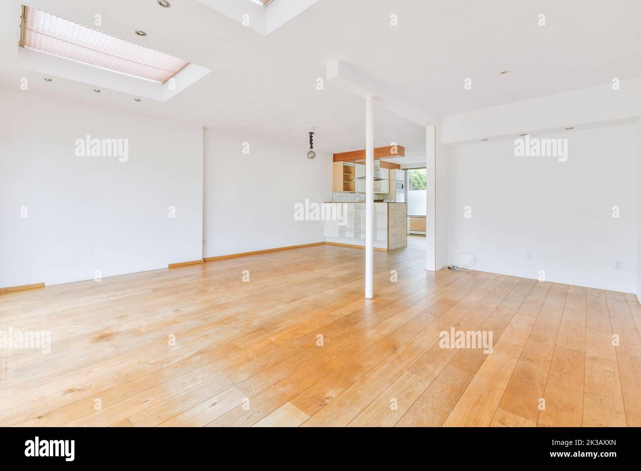 Interior of empty white kitchen with windows and wooden parquet floor ...