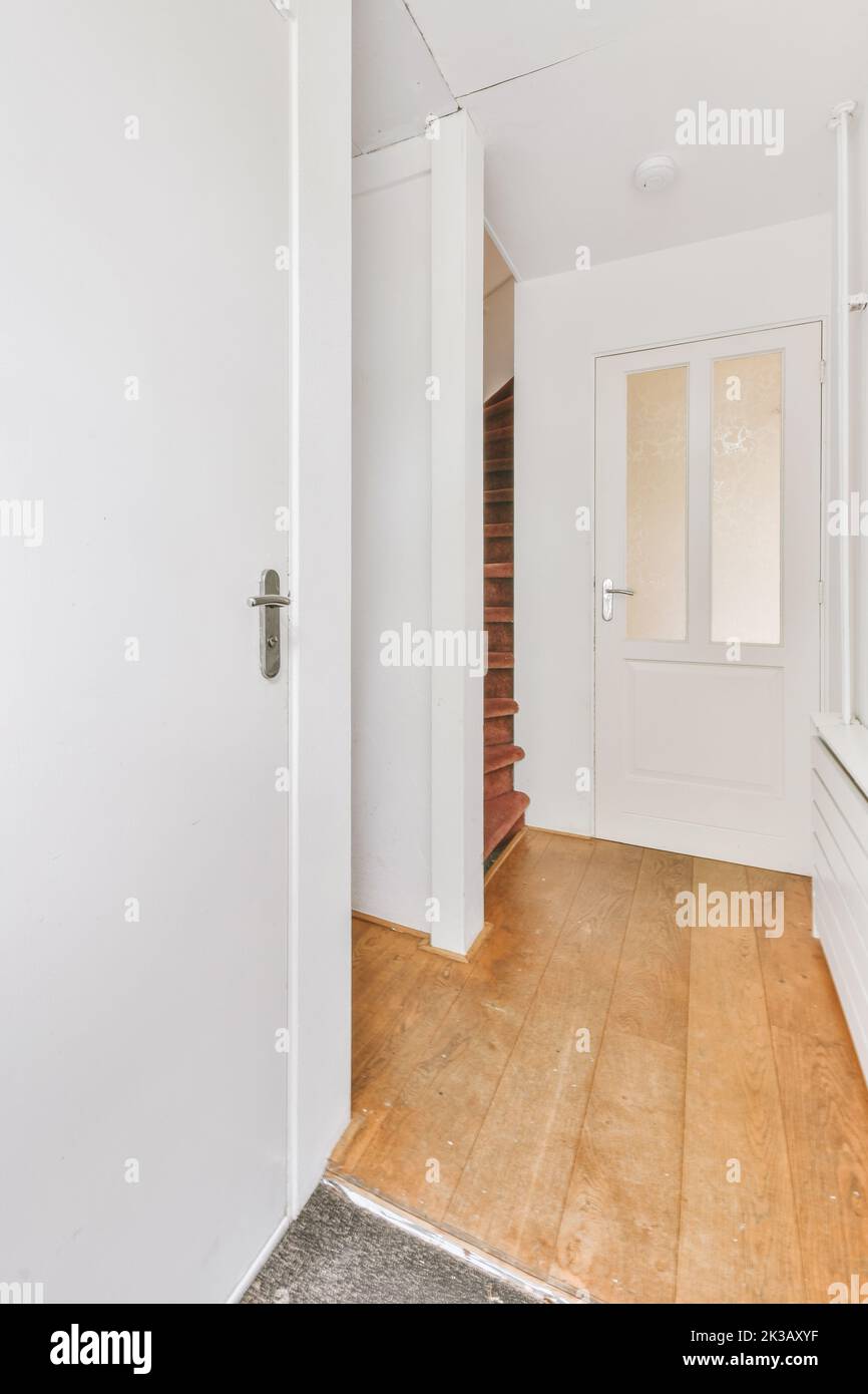 Light narrow hallway with many doors in white walls and glowing lamp ...
