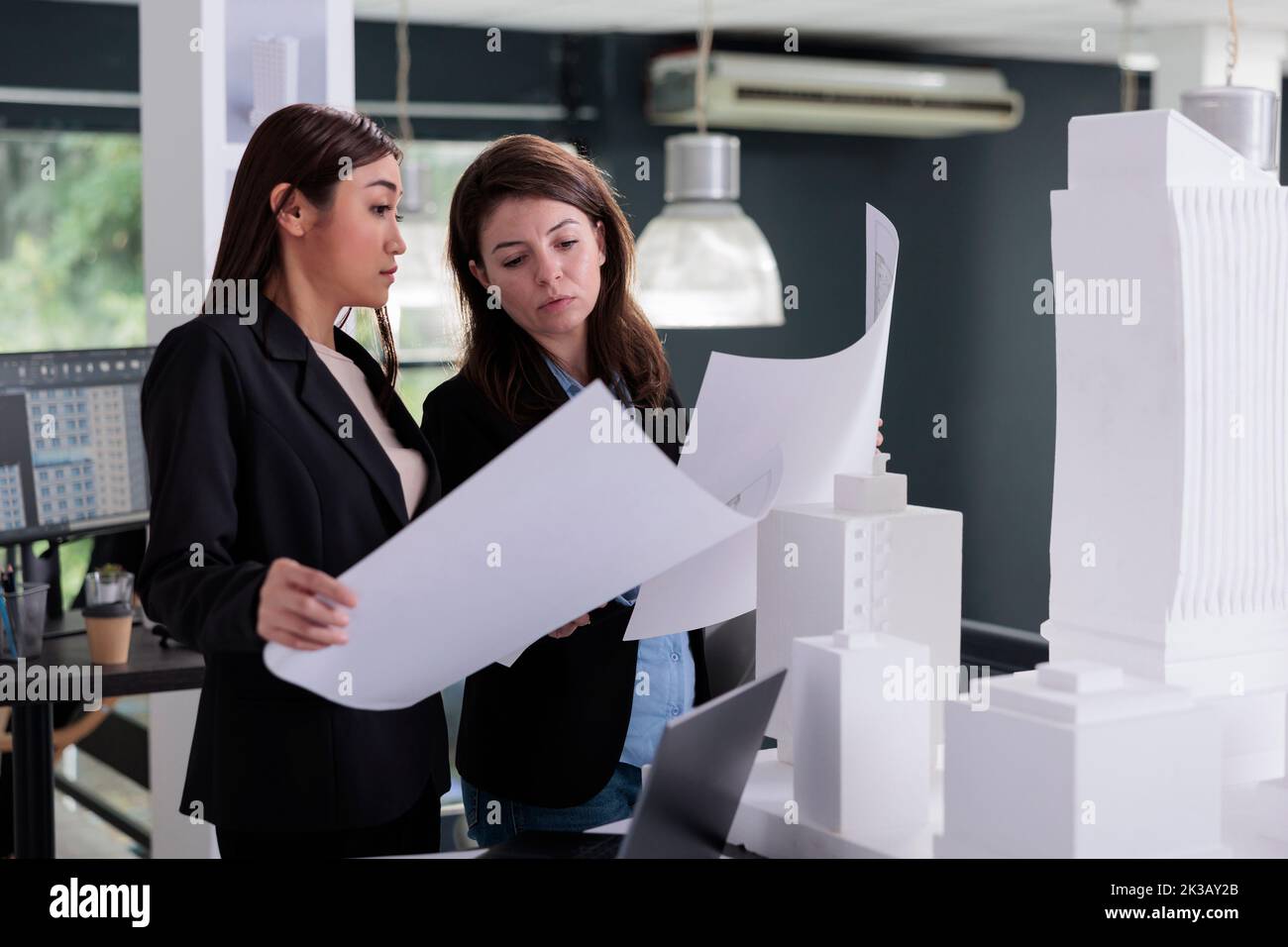 Architects discussing blueprint, working on cad, holding building ... Architects discussing blueprint, working on cad, holding building ...