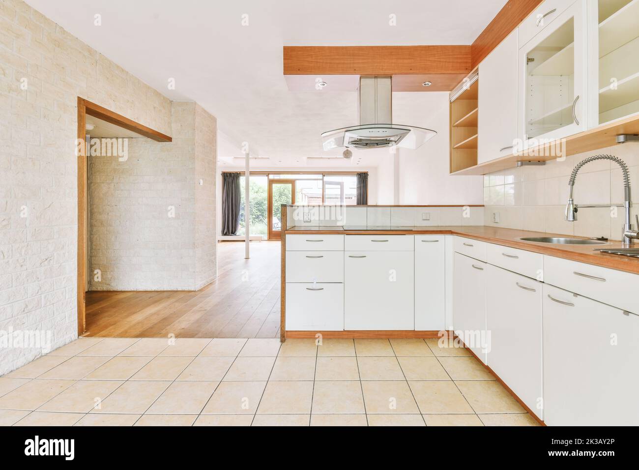 Interior of empty white kitchen with windows and wooden parquet floor ...