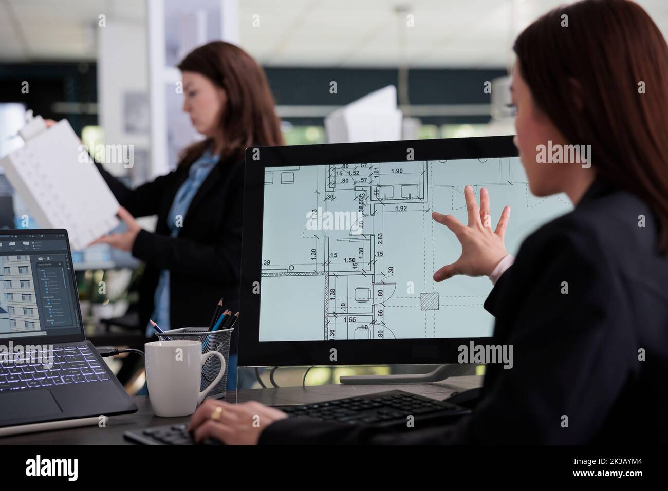 Woman working in room floor planner software, zooming in project draft ...