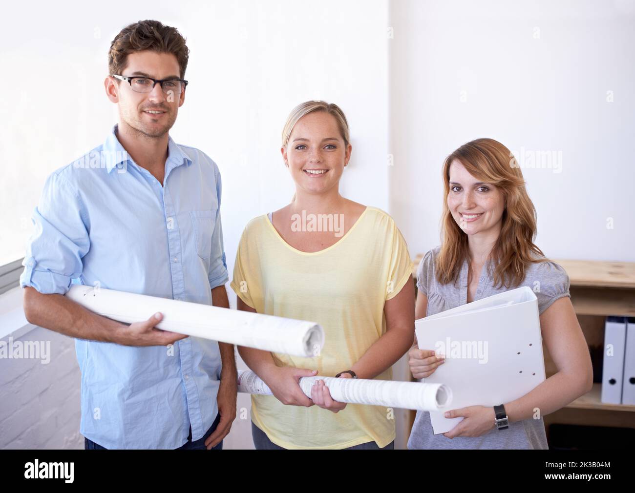 The plans are ready. A group of architects standing together in a row ...