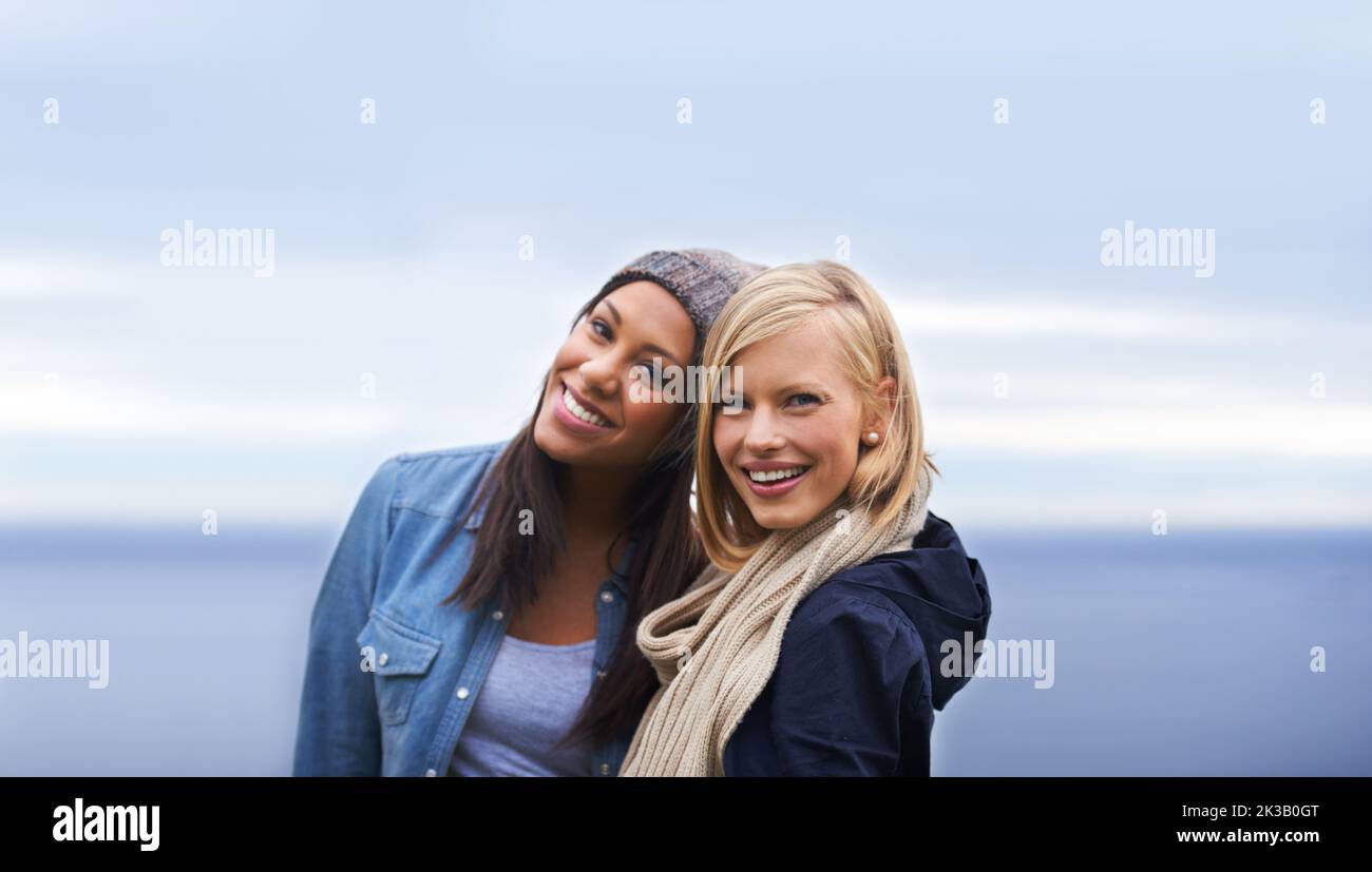 Friendship and laughter can warm up any day. Two happy young women ...