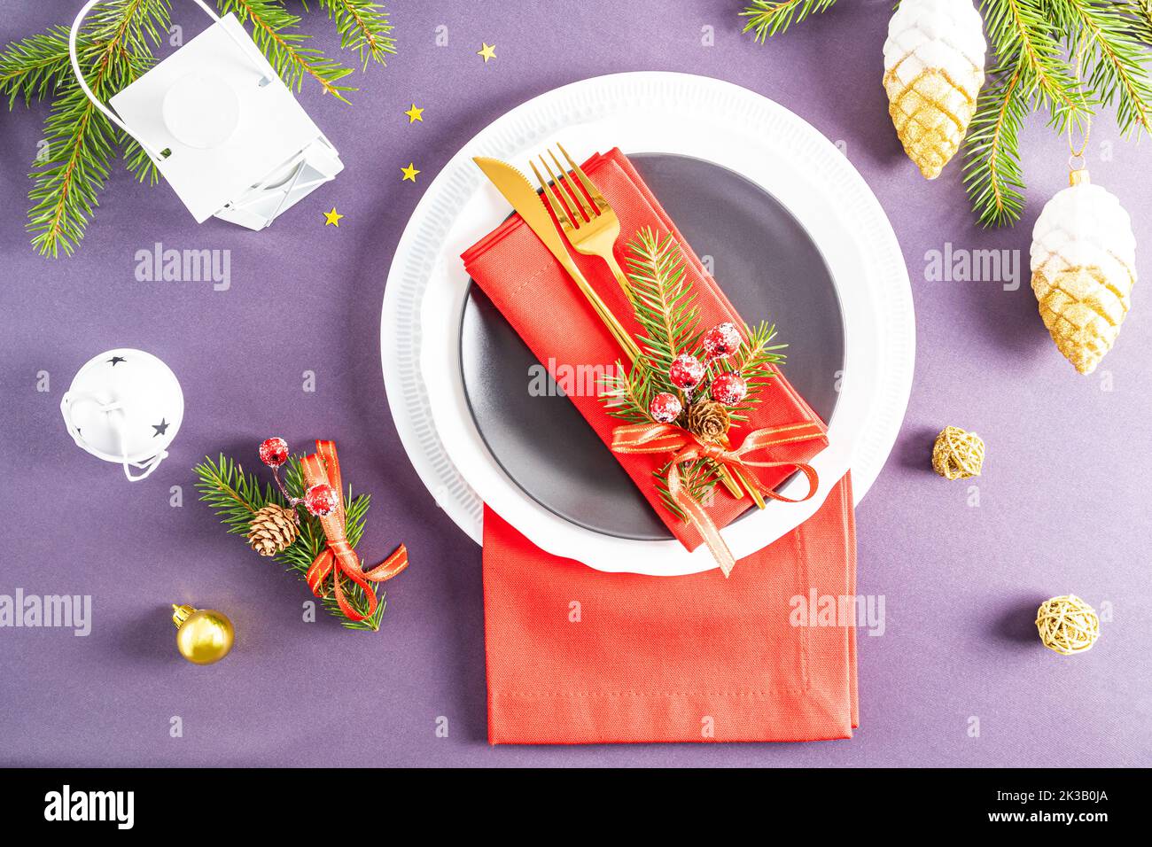 beautiful New Year's serving of the festive table with plates, red ...