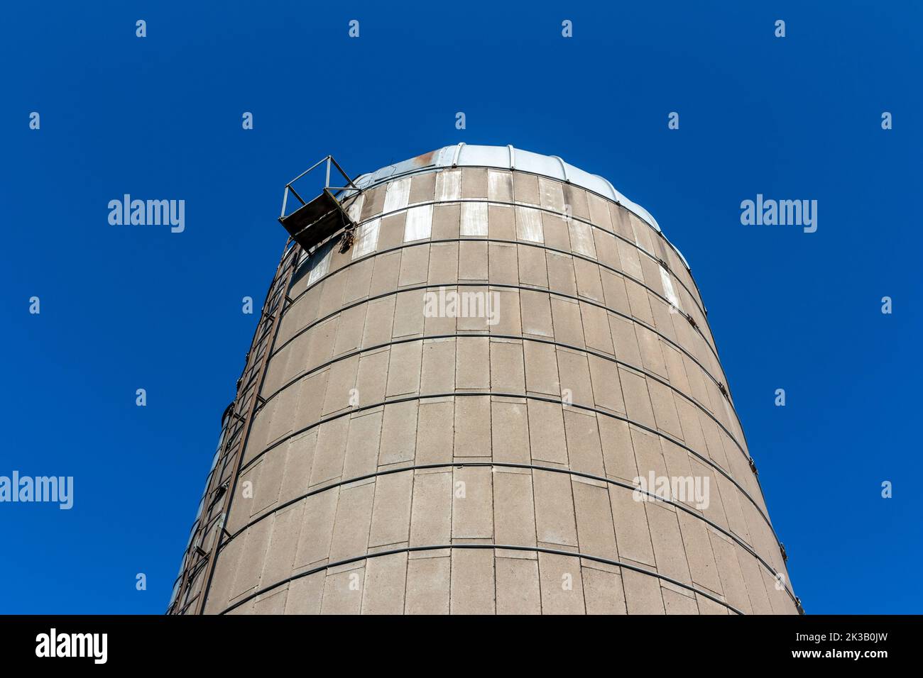 Close up low angle view of a vintage round concrete wall silo with a ...