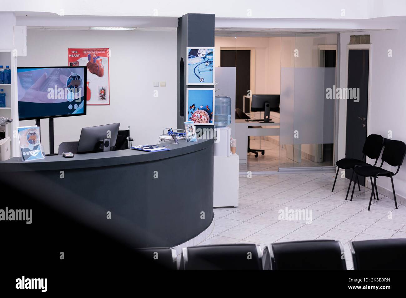 Empty hospital reception counter in hallway and waiting room seats ...