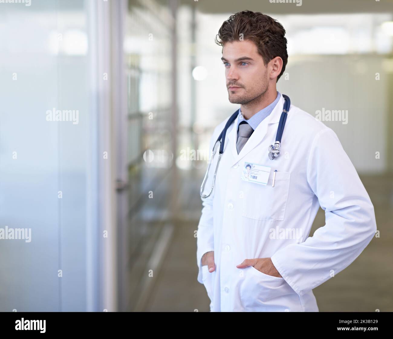 Considering his patients treatment options. a handsome young doctor ...