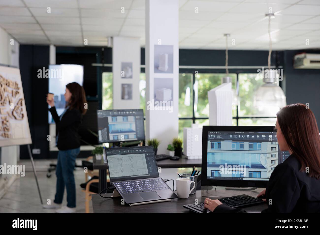 Architect working in 3d modeling software, multi store building model ...