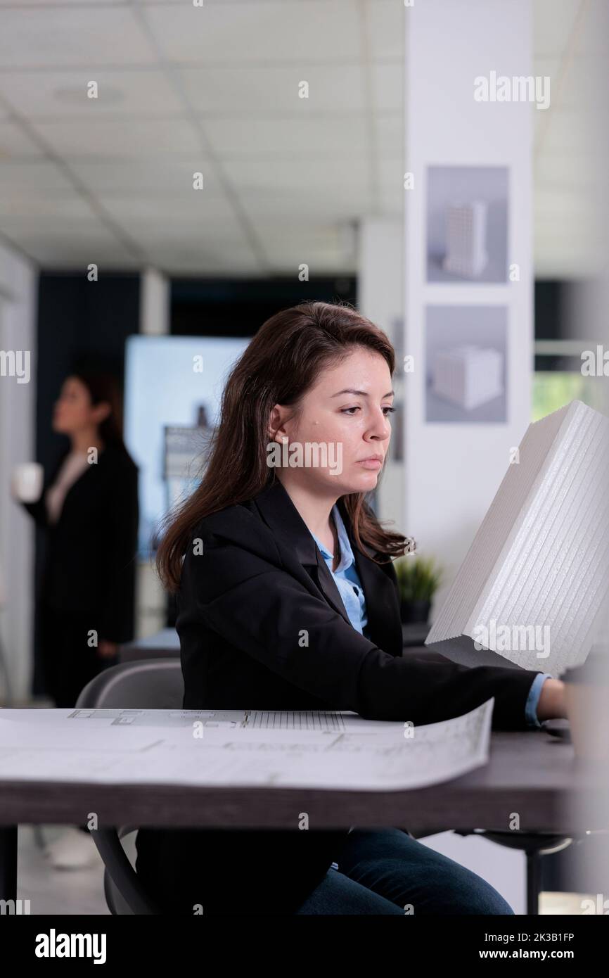 Architecture office employee holding building 3d printed model, working ...