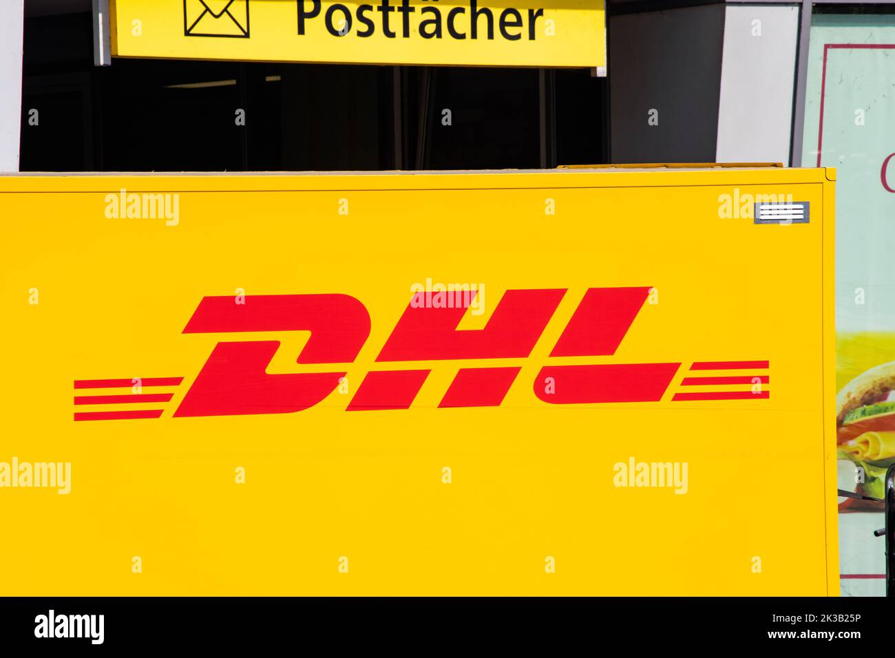 23 July 2022, Dusseldorf, Germany: DHL delivery truck near german post ...