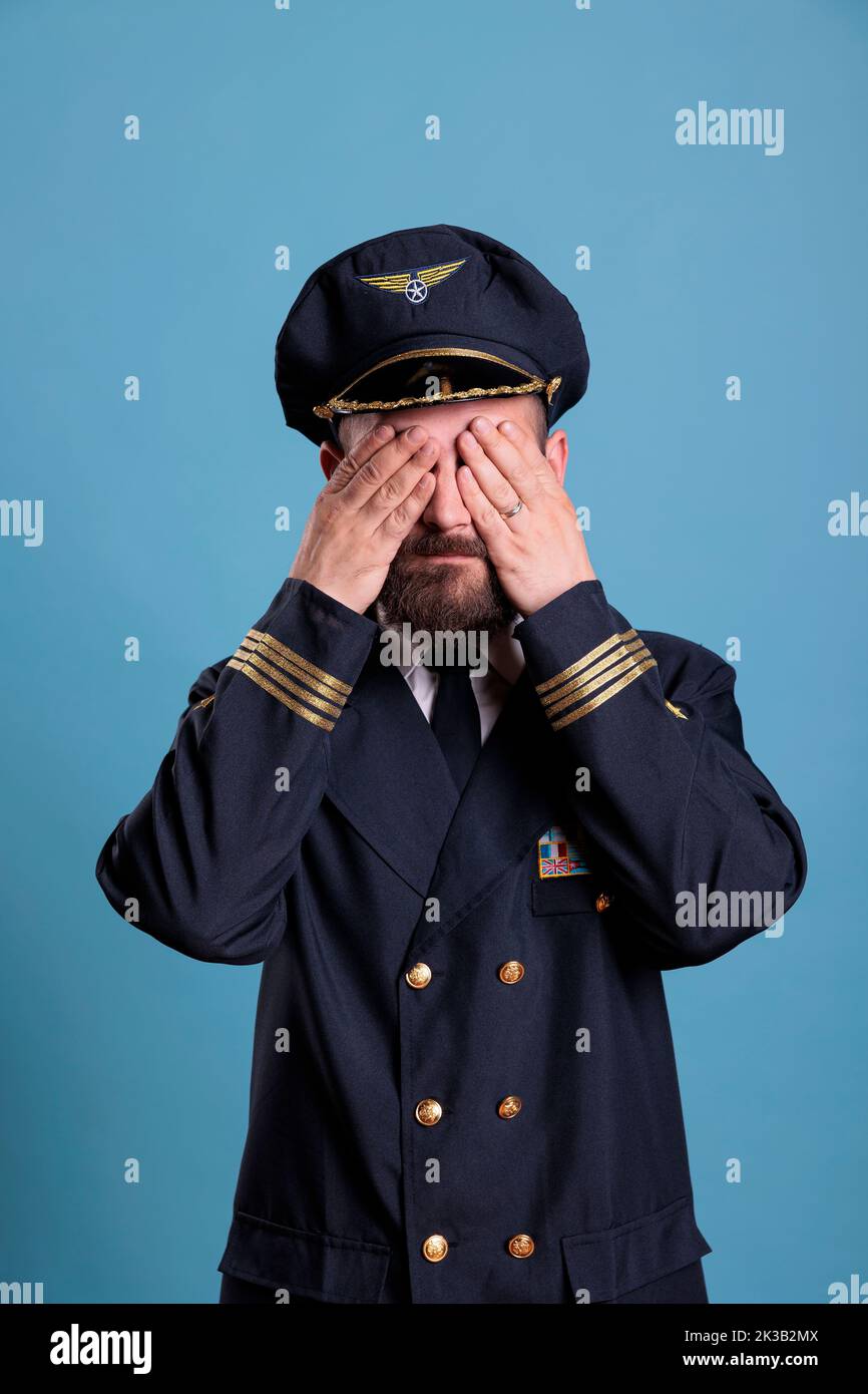 Airplane pilot covering eyes with hands, man showing see no evil moral ...