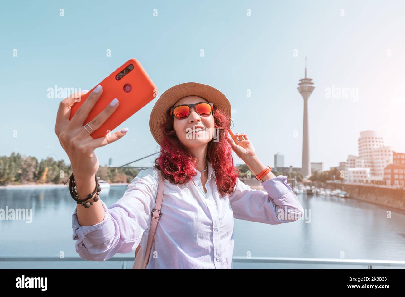 Happy girl travel blogger takes selfie pictures on her smartphone of ...