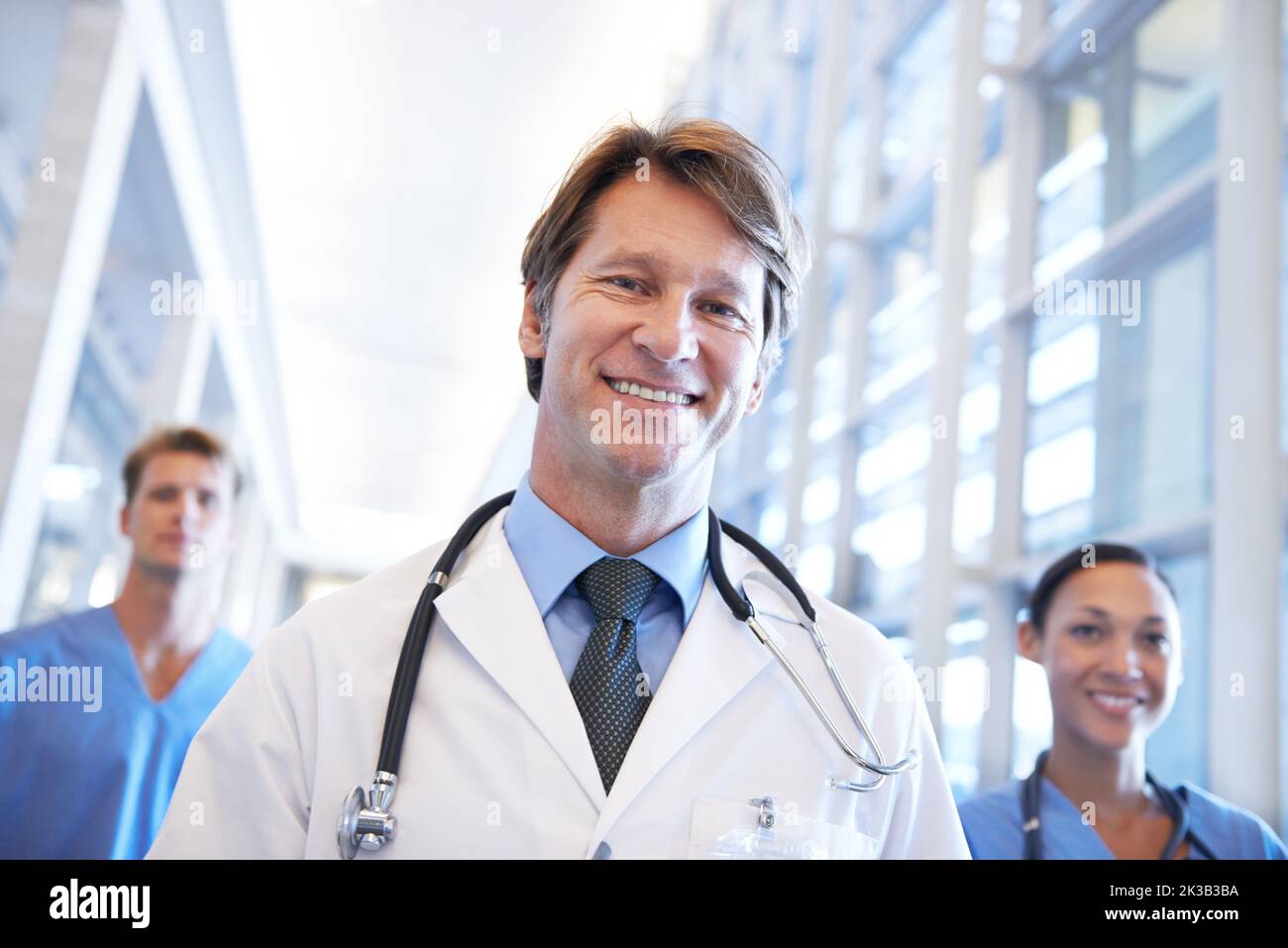 Leading his medical team with perfection. A medical team standing in the hospital corridor Stock ...