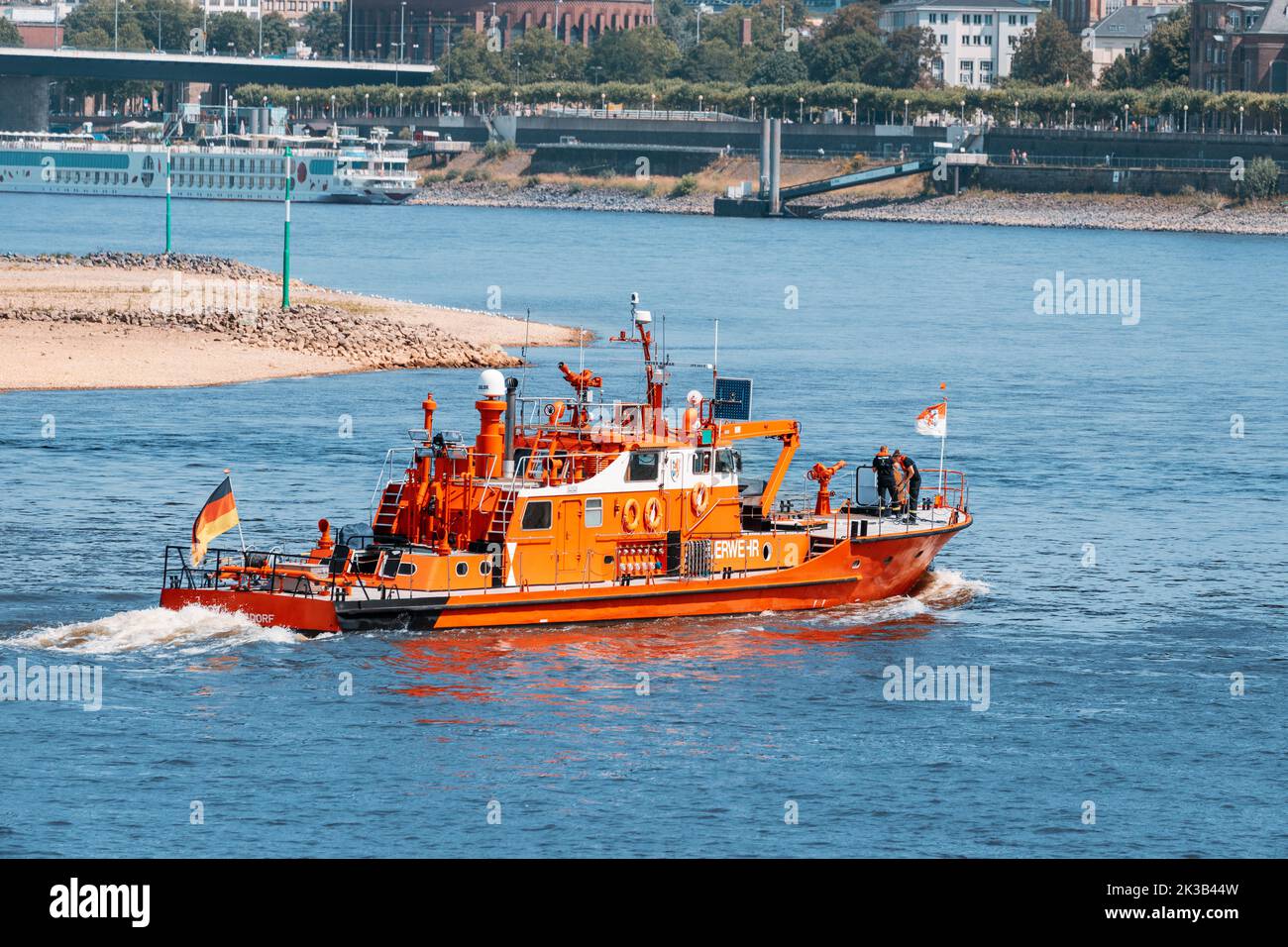 23 July 2022, Dusseldorf, Germany: Firefighting boat patrolling the ...