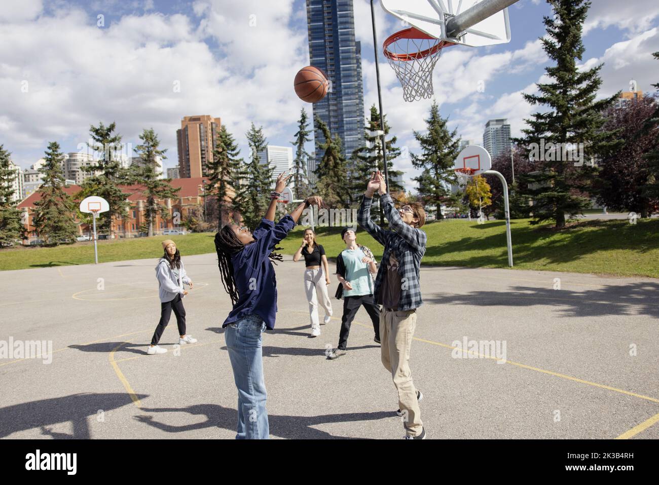 Teen girls playing basketball outdoors hi-res stock photography and ...