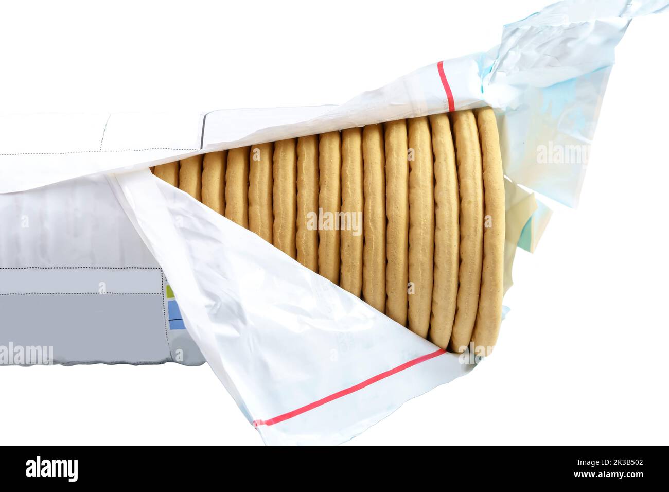 A stack of hole round bread crackers in an open packaging isolated on ...
