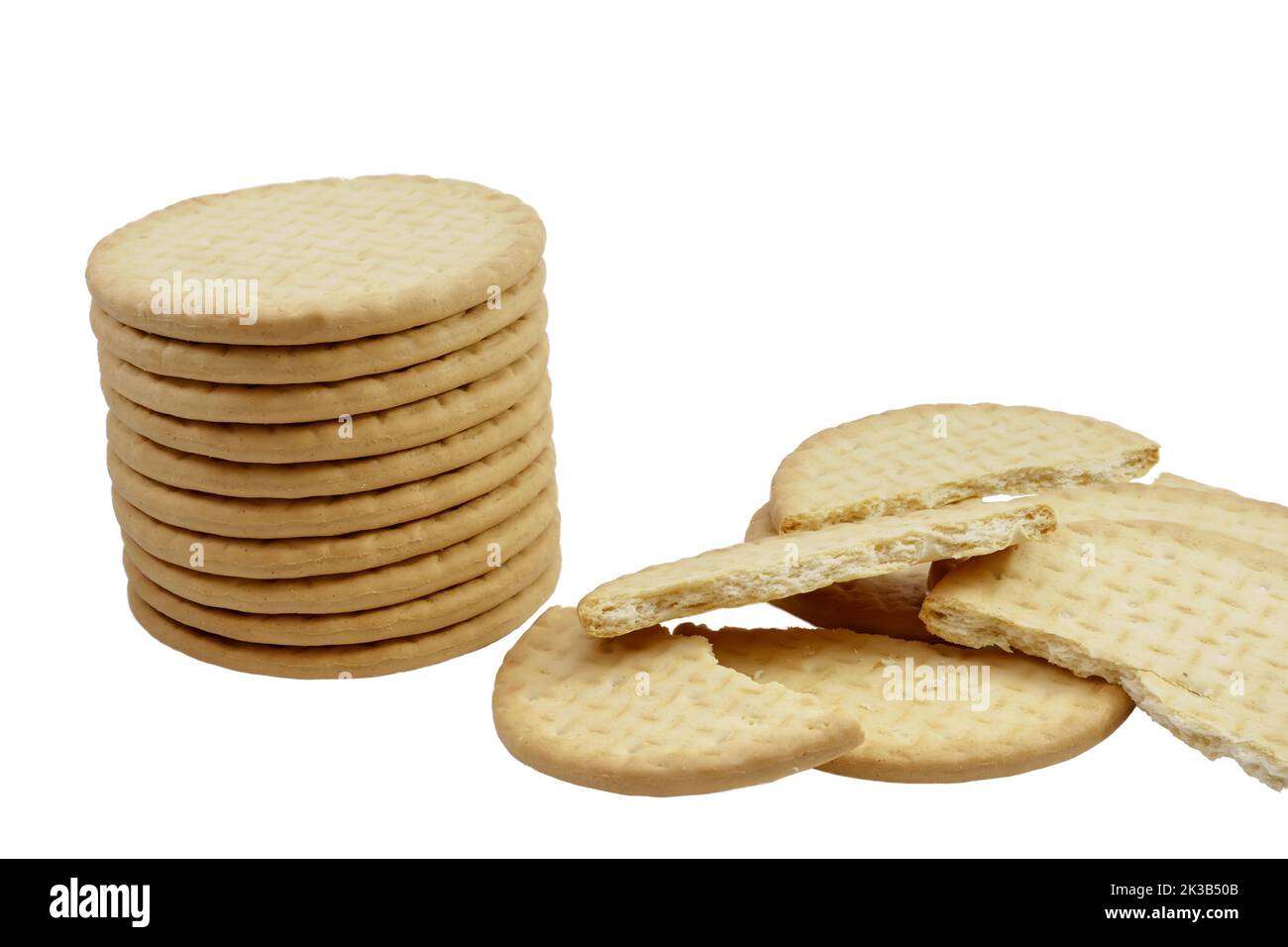 The cracked crackers next to stack of round whole bread crackers ...