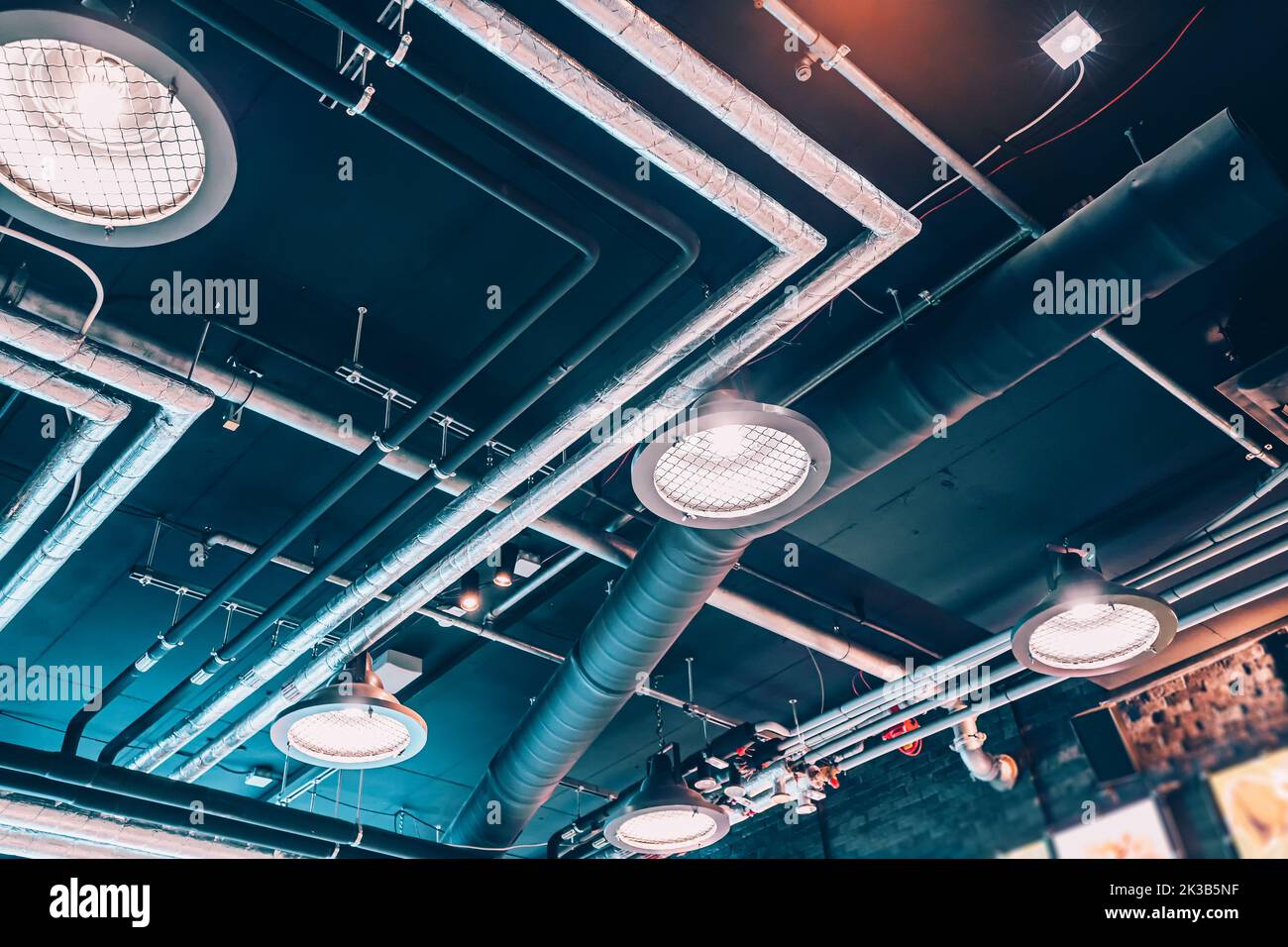 ceiling with ventilation pipes and communication boxes with cables in ...