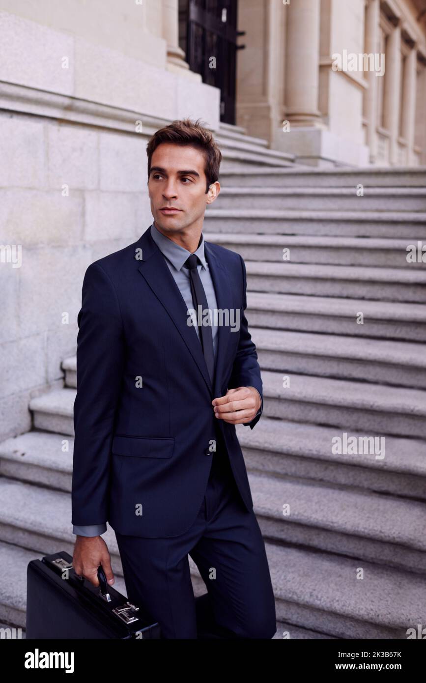 Corporate confidence. A handsome businessman standing with his ...