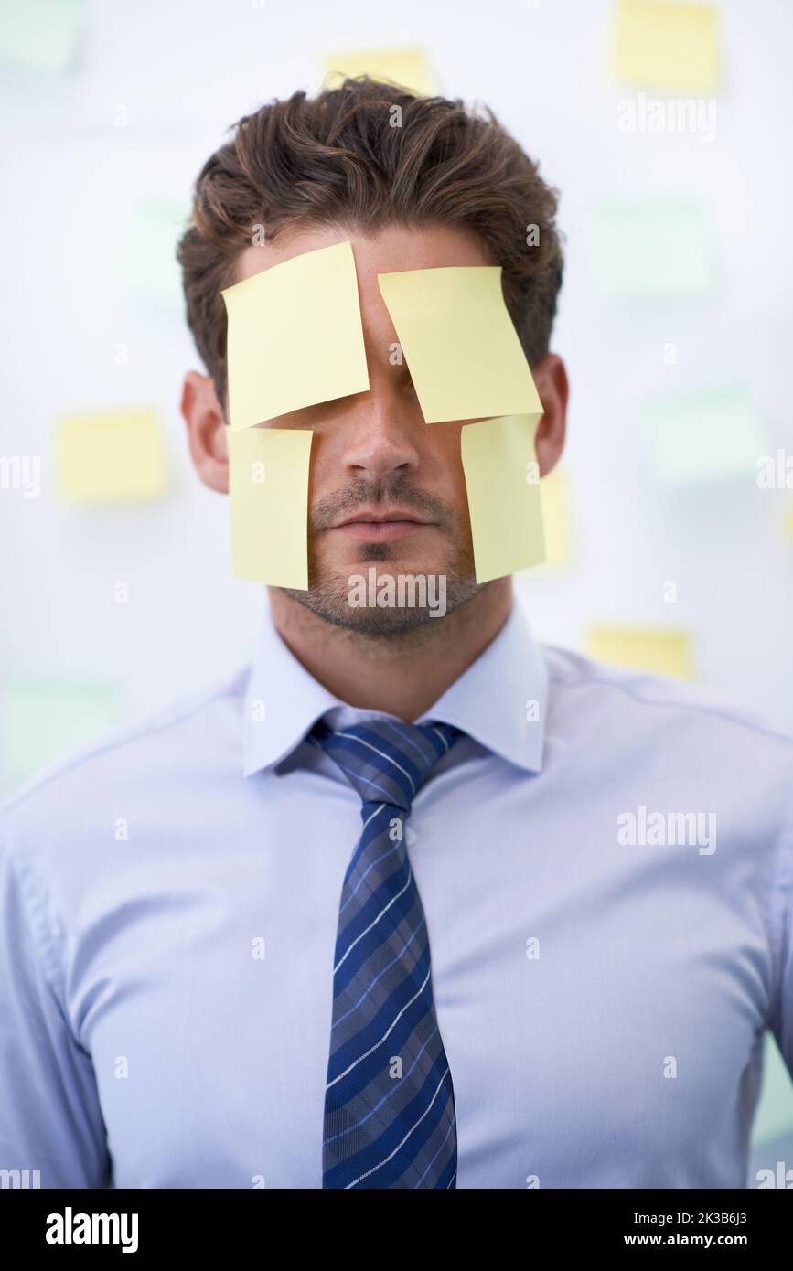 Hiding from his responsibilities. a young businessman with a sticky ...