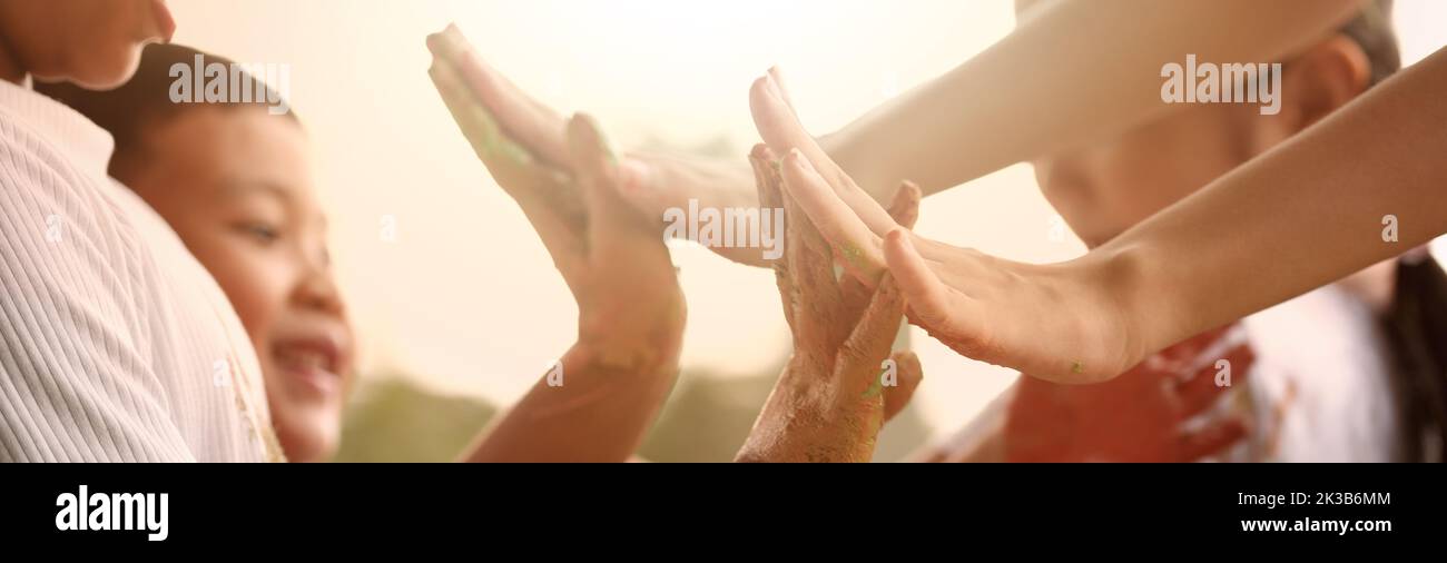 Happy children giving high five after a kid's plays outside in the ...