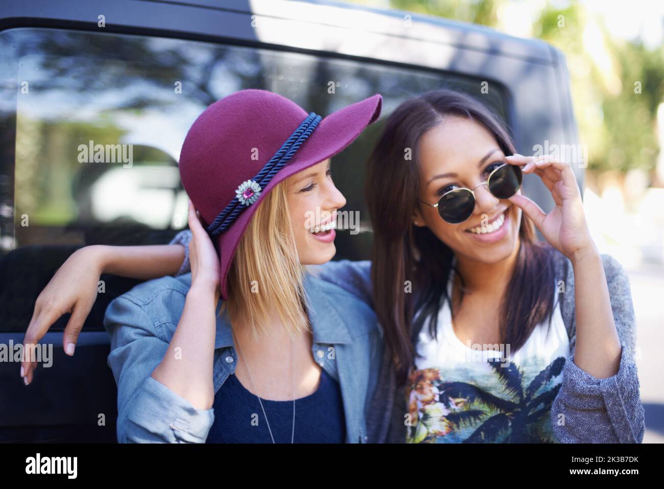 Girls just wanna have fun. Portrait of two young female friends leaning ...