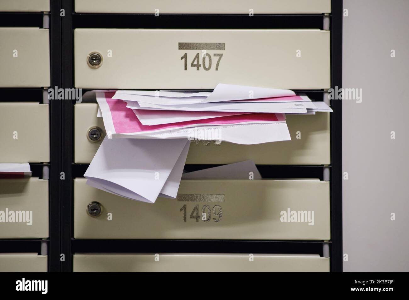 An overflowing mailbox in the lobby of an apartment building. Mailboxes ...