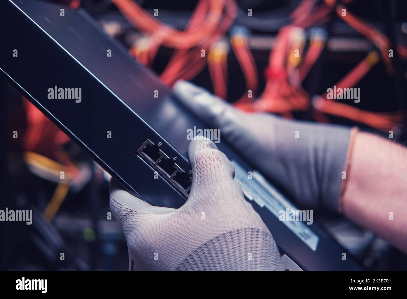 Router in the hands of a man at the server for storing data, close-up ...