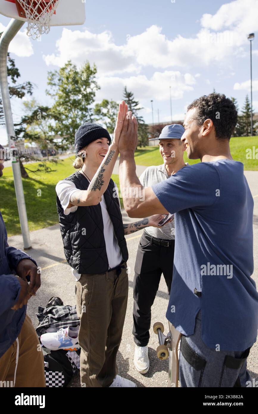 High fiving friends hi-res stock photography and images - Alamy