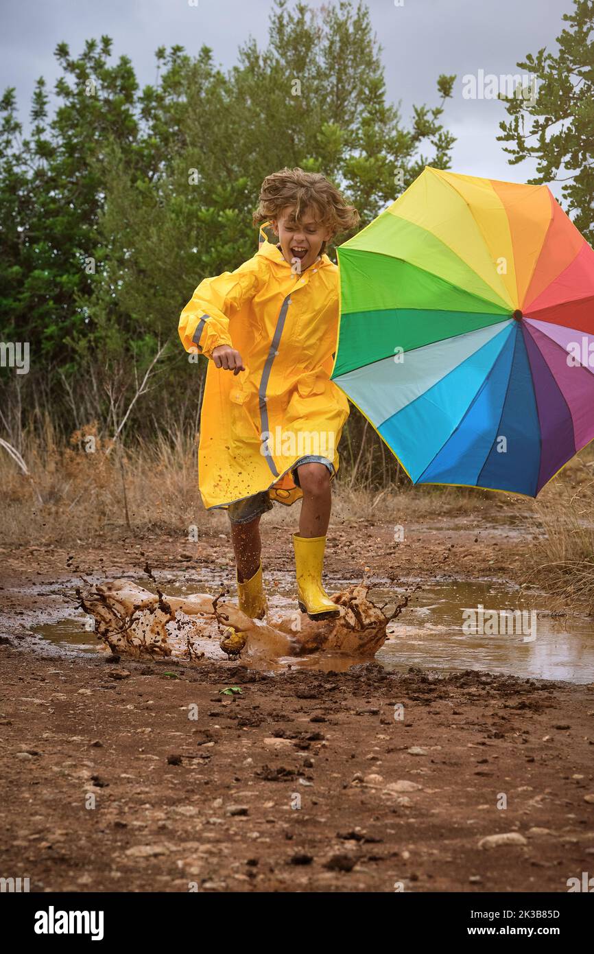 Boy running through puddles hi-res stock photography and images - Alamy