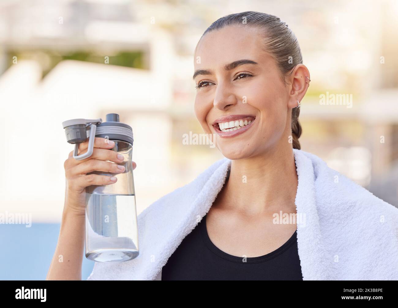 Fitness, athlete woman with water bottle for her exercise or outdoor workout with sunshine and a ...