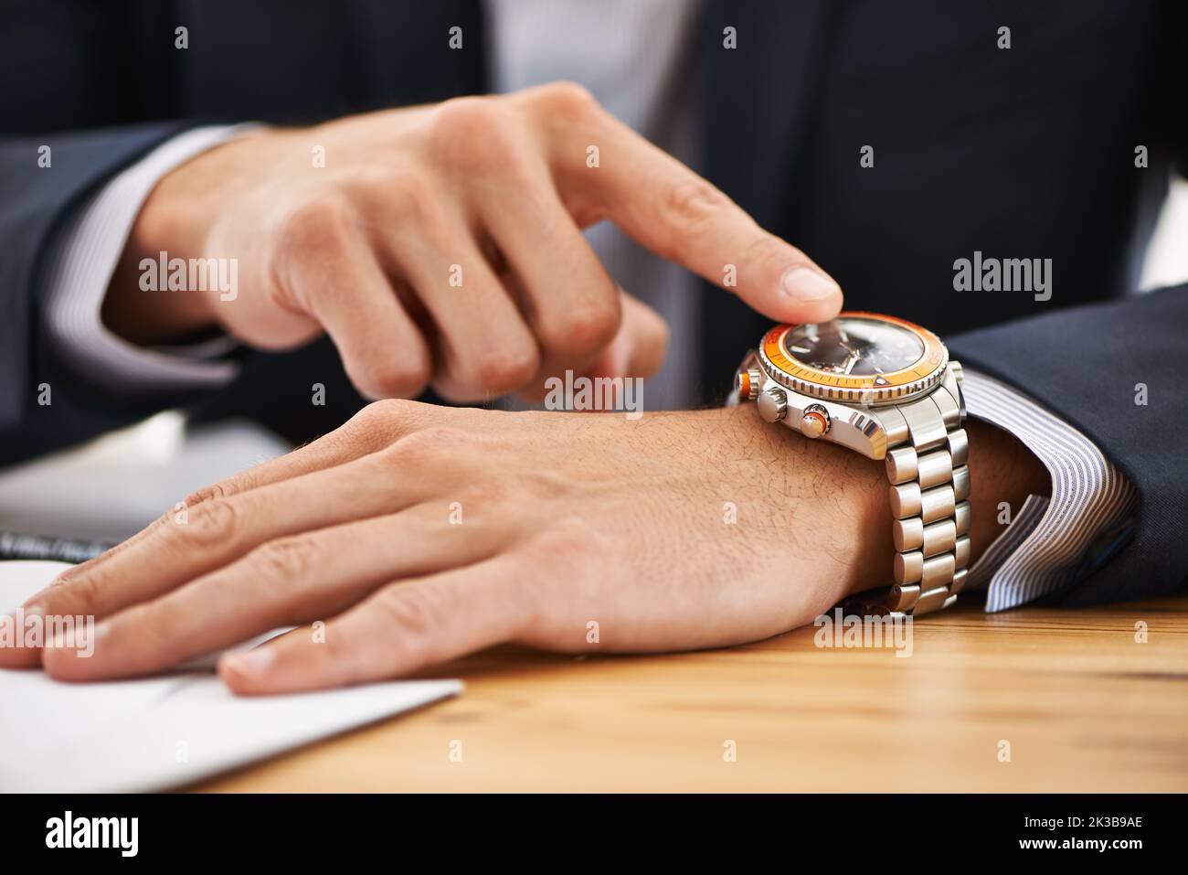 Making sure he sticks to the schedule. a businessman checking the time ...